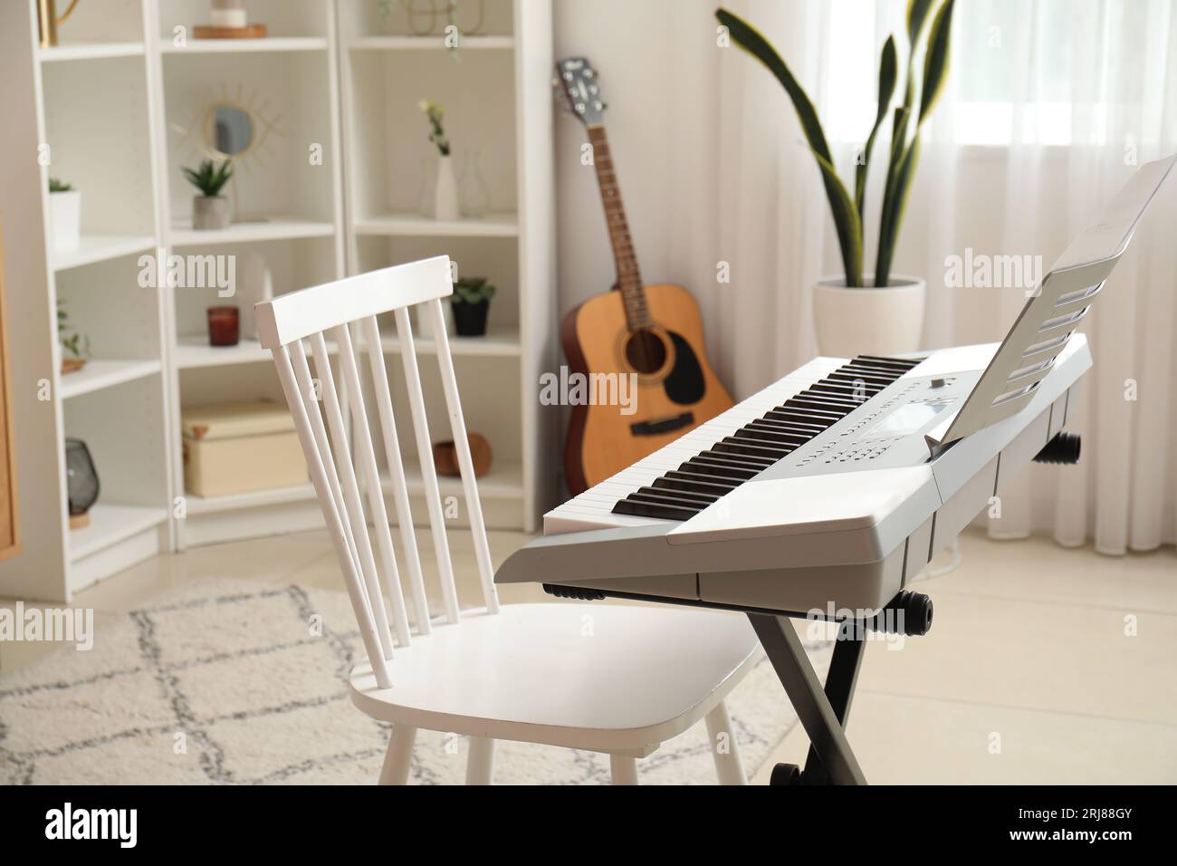 Interior of modern room with synthesizer and shelving unit Stock Photo ...