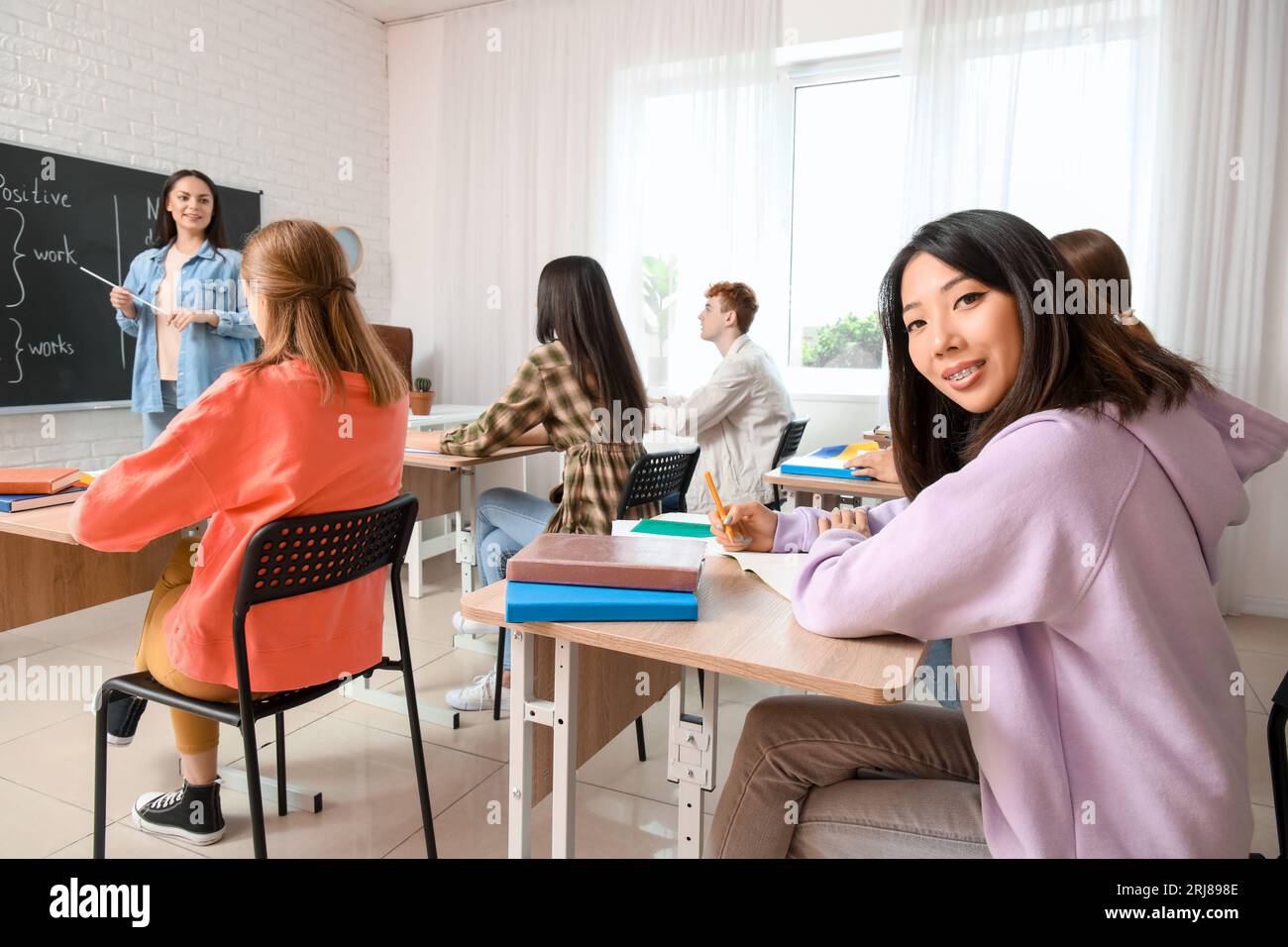 Group university students sitting desks hi-res stock photography and ...