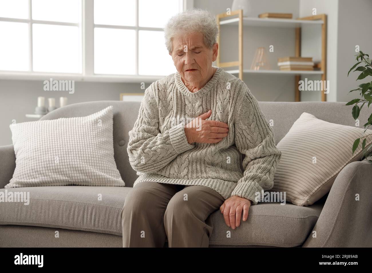 Heart attack aged female sitting hi-res stock photography and images ...