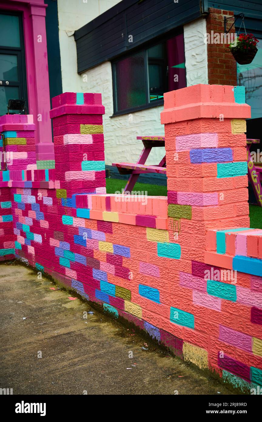 Multi-coloured brick wall infront of Blackpool Hotel Stock Photo - Alamy
