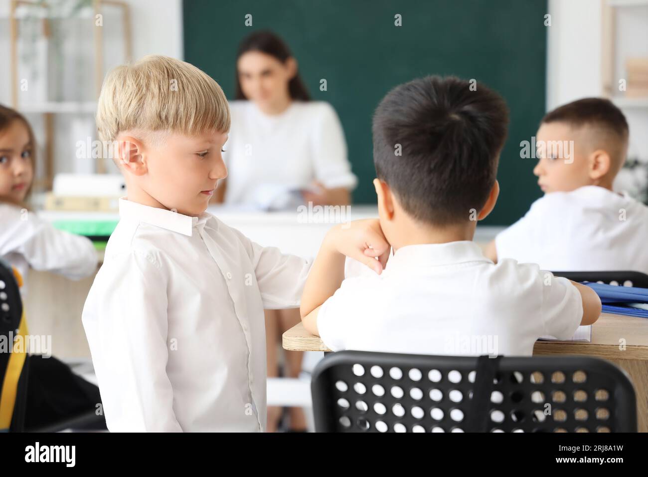Little school boys in classroom during lesson Stock Photo - Alamy