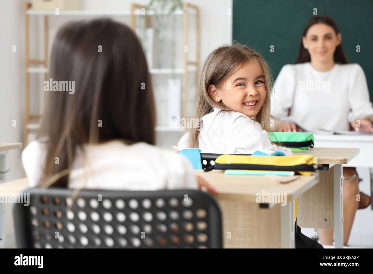 Little school girl in classroom during lesson Stock Photo - Alamy