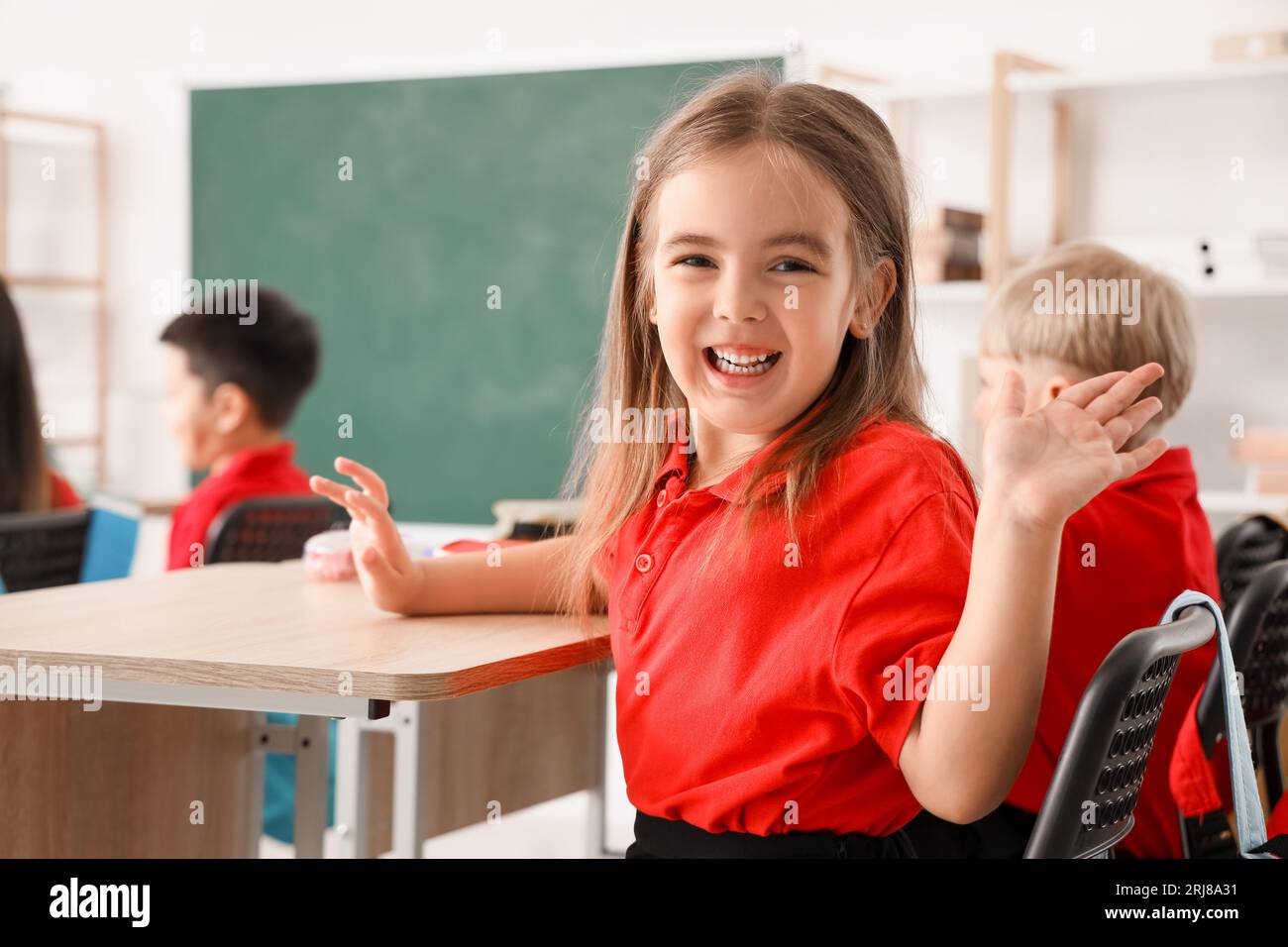 Little school girl in classroom during lesson Stock Photo - Alamy