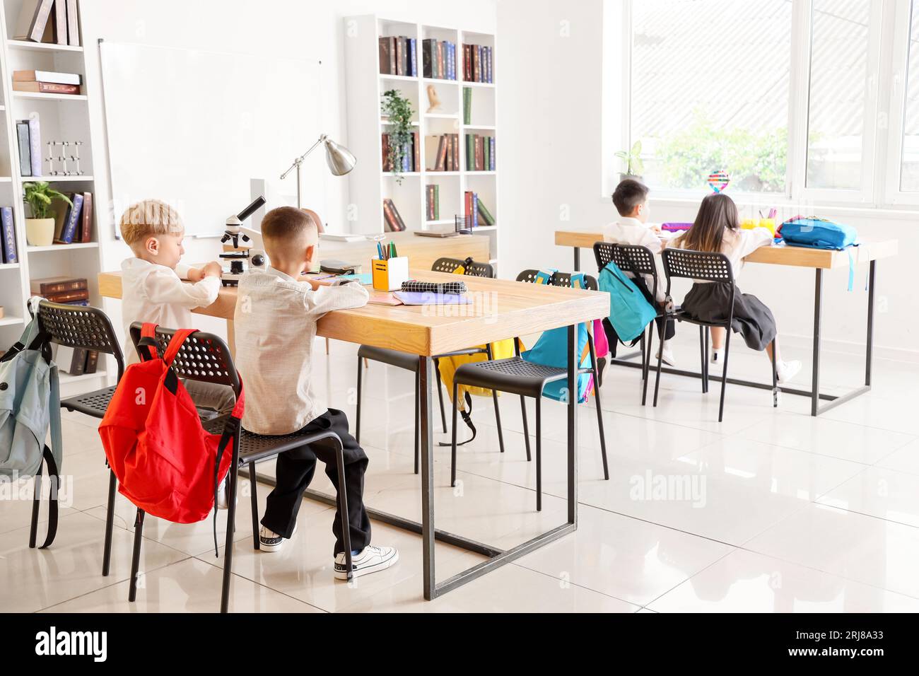 Little school children in classroom during lesson Stock Photo - Alamy