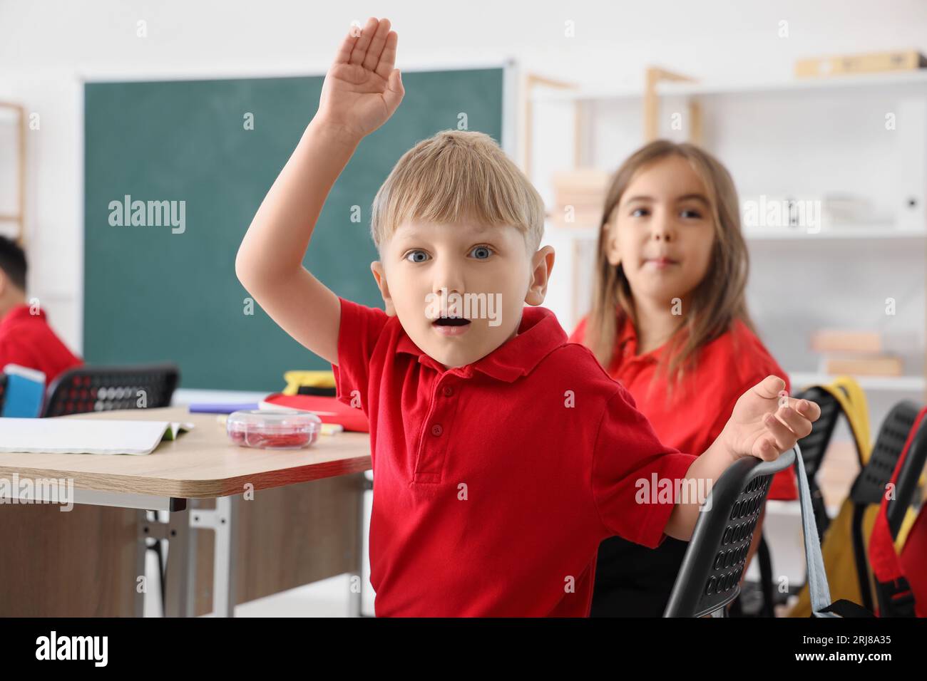 Emotional little school boy in classroom during lesson Stock Photo - Alamy
