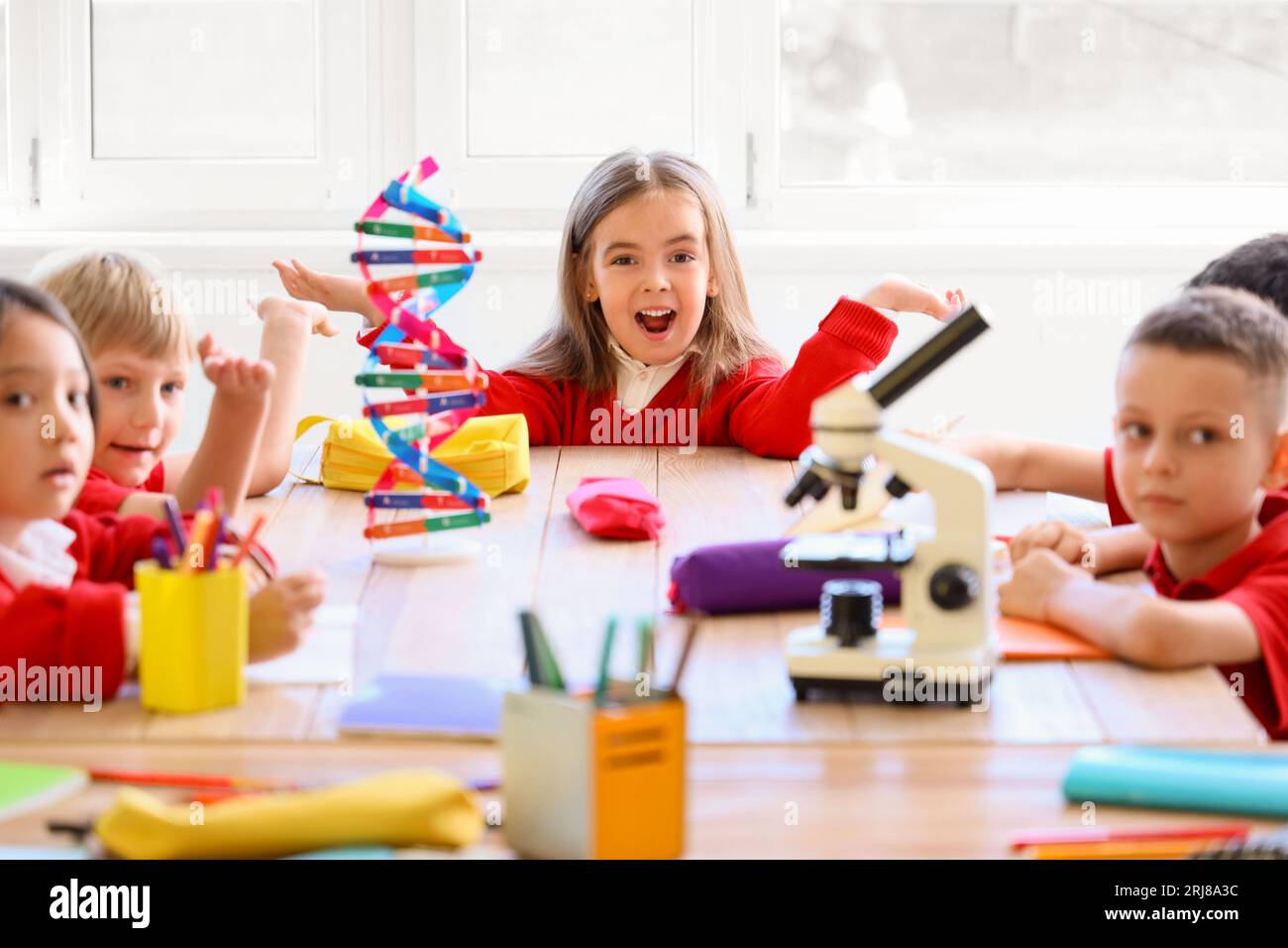 Little school children in classroom during lesson Stock Photo - Alamy