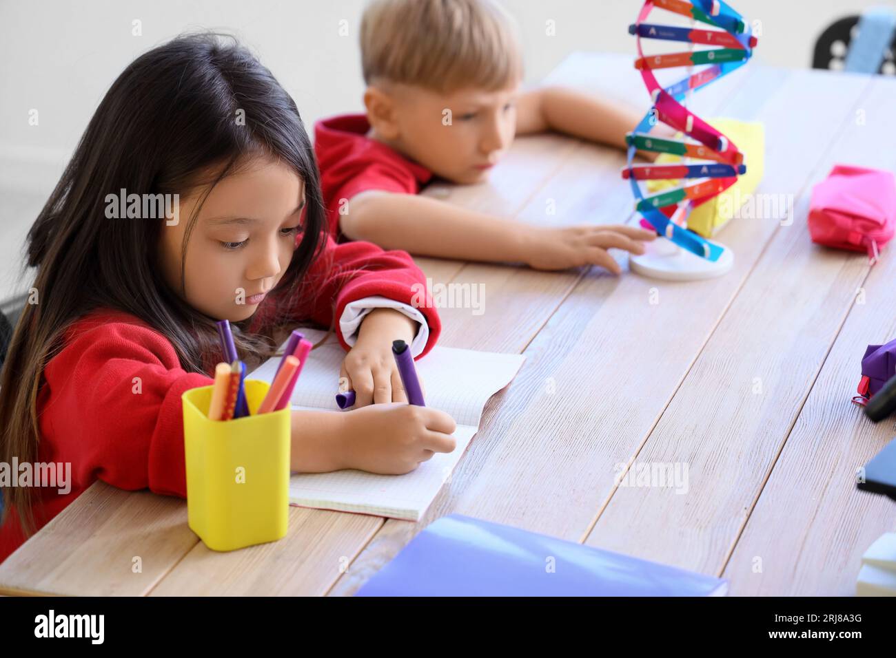 Little school children in classroom during lesson Stock Photo - Alamy