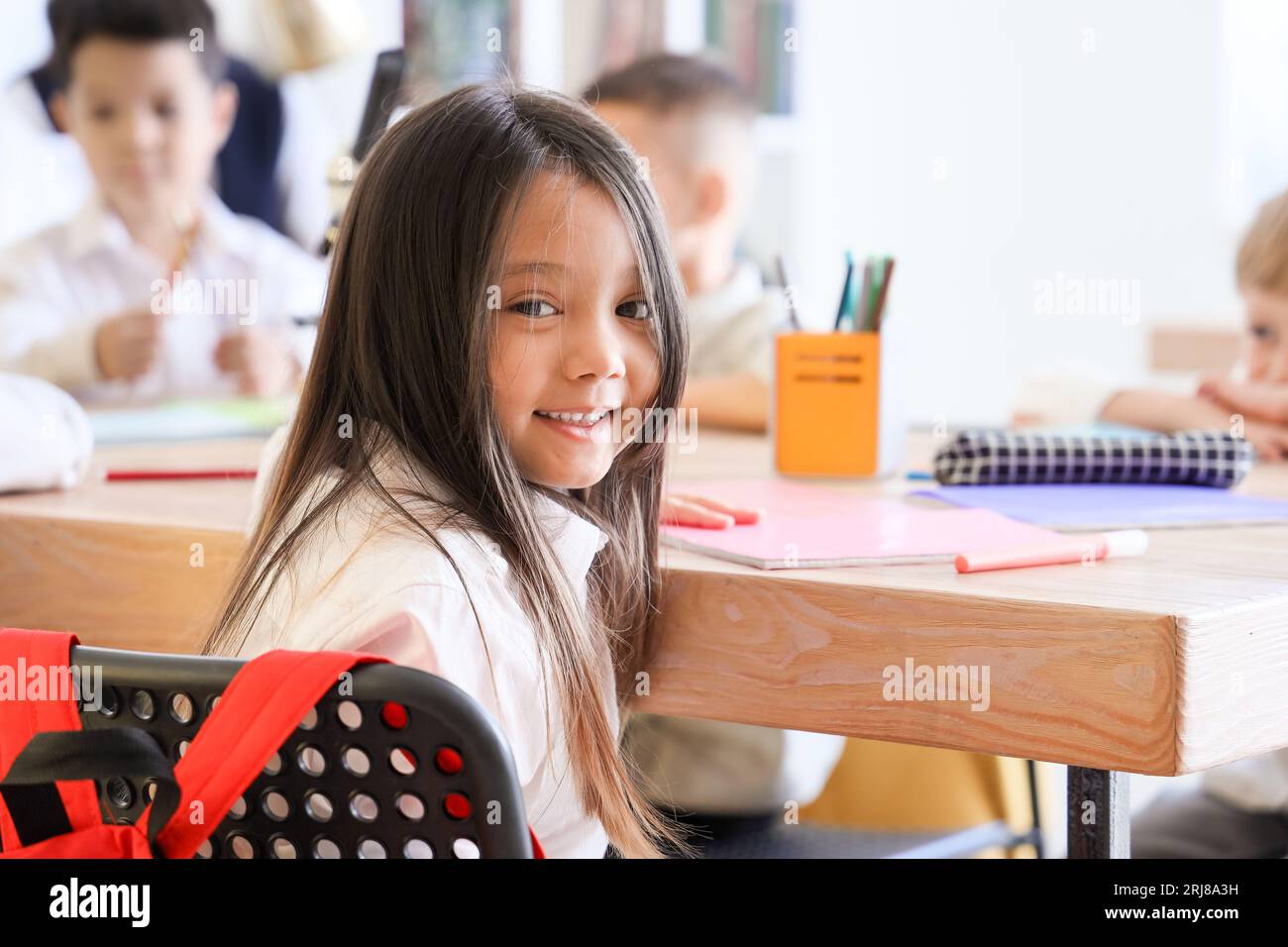 Little school girl in classroom during lesson Stock Photo - Alamy