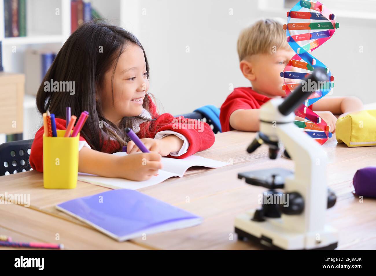 Little school children in classroom during lesson Stock Photo - Alamy