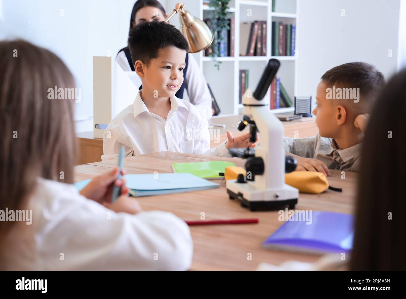 Little school children in classroom during lesson Stock Photo - Alamy