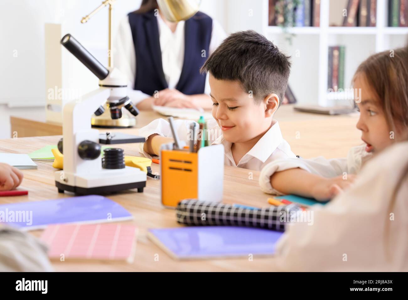 Little school children in classroom during lesson Stock Photo - Alamy