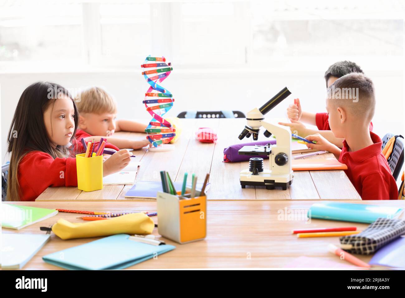 Little school children in classroom during lesson Stock Photo - Alamy