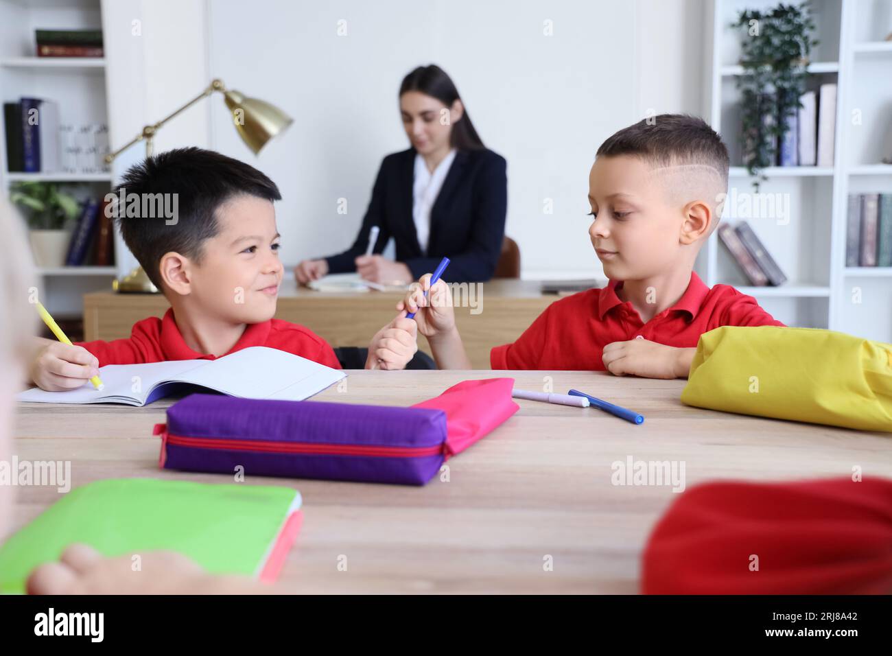Little school children in classroom during lesson Stock Photo - Alamy