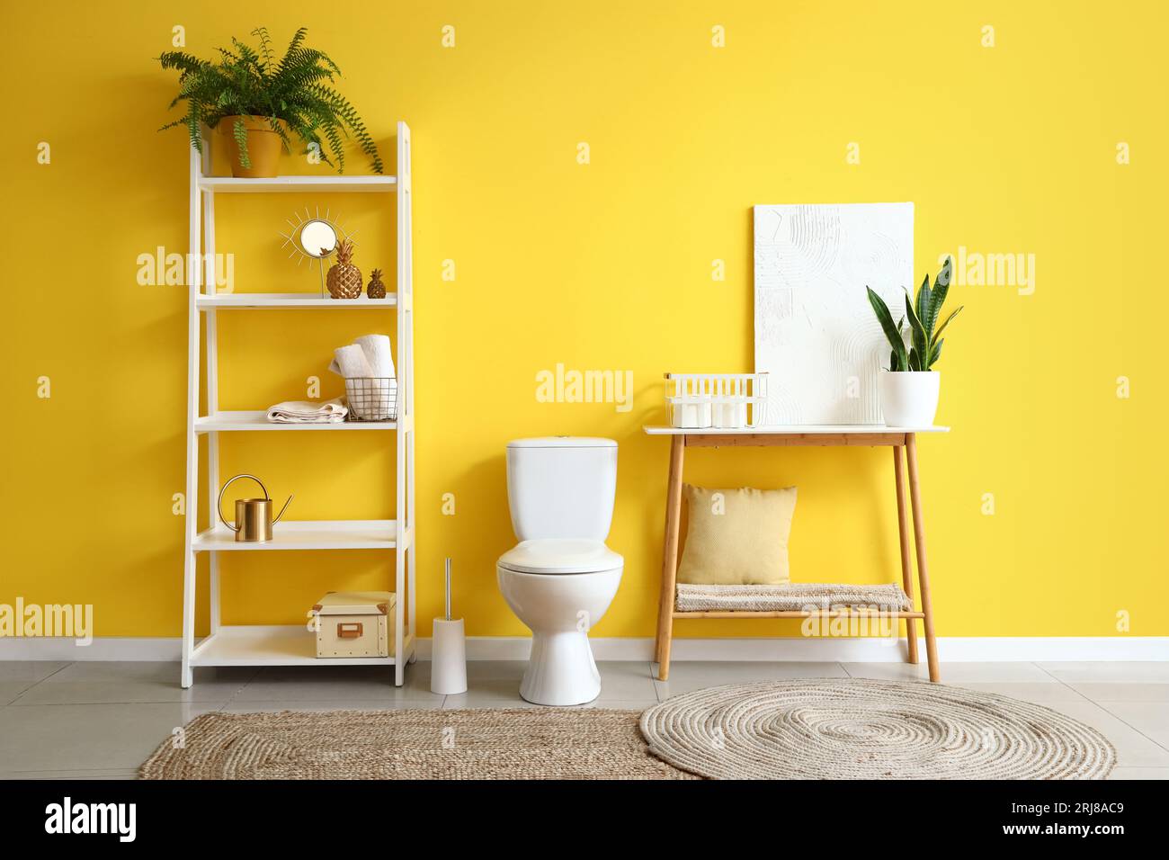 Interior of modern restroom with ceramic toilet bowl, shelving unit and ...