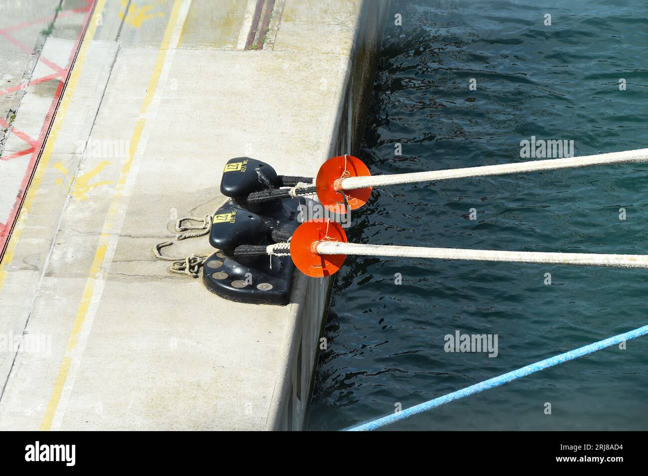 Mooring ropes attached to quay side mooring bollards in Southampton ...