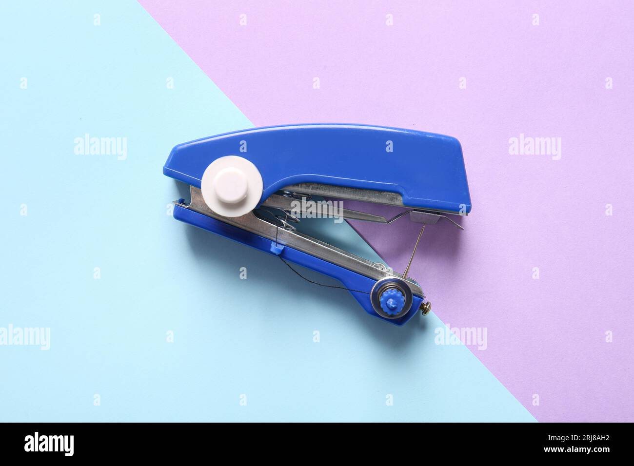 Manual sewing machine on color background Stock Photo - Alamy