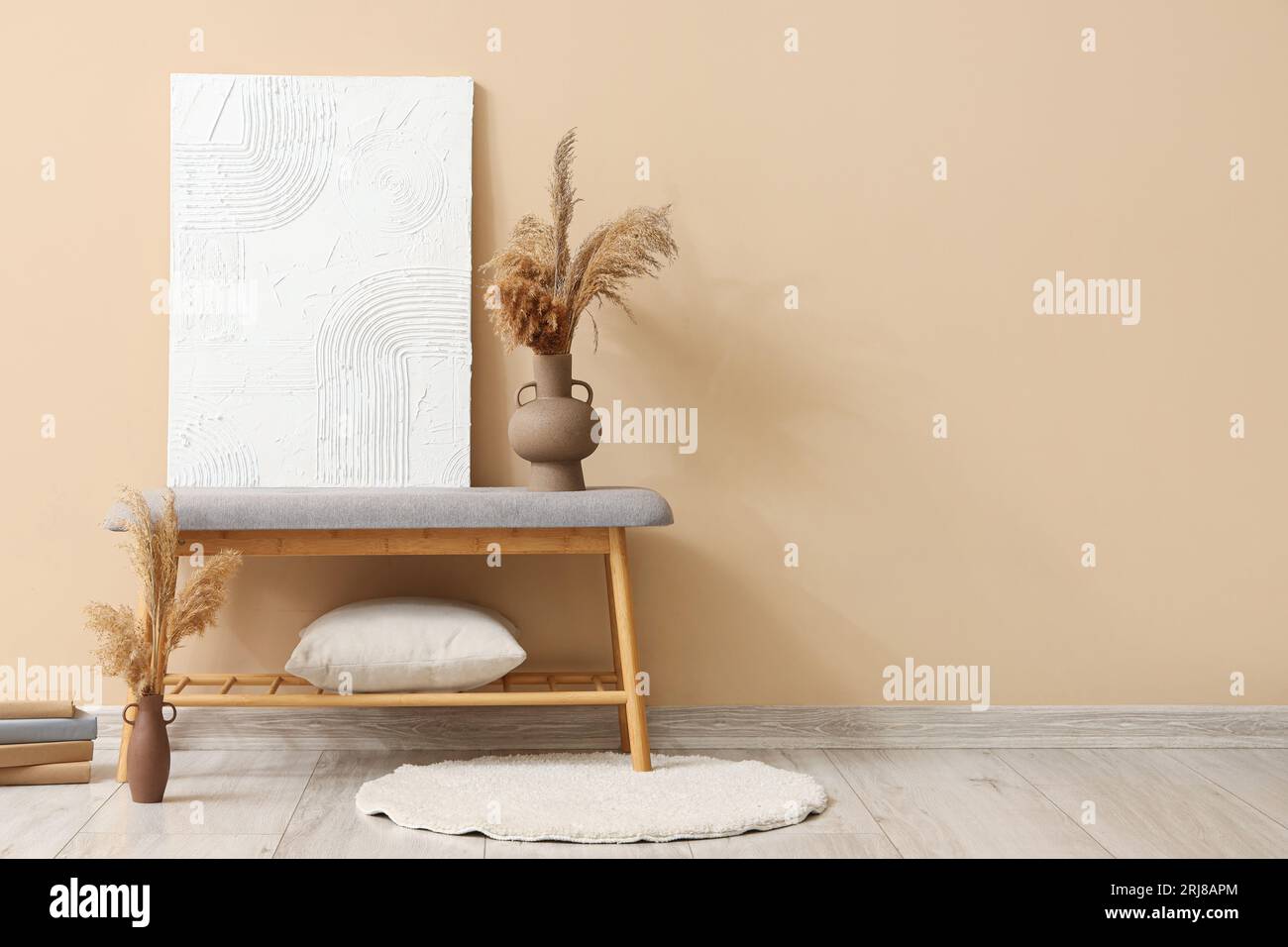 Interior of stylish room with soft bench near beige wall Stock Photo ...