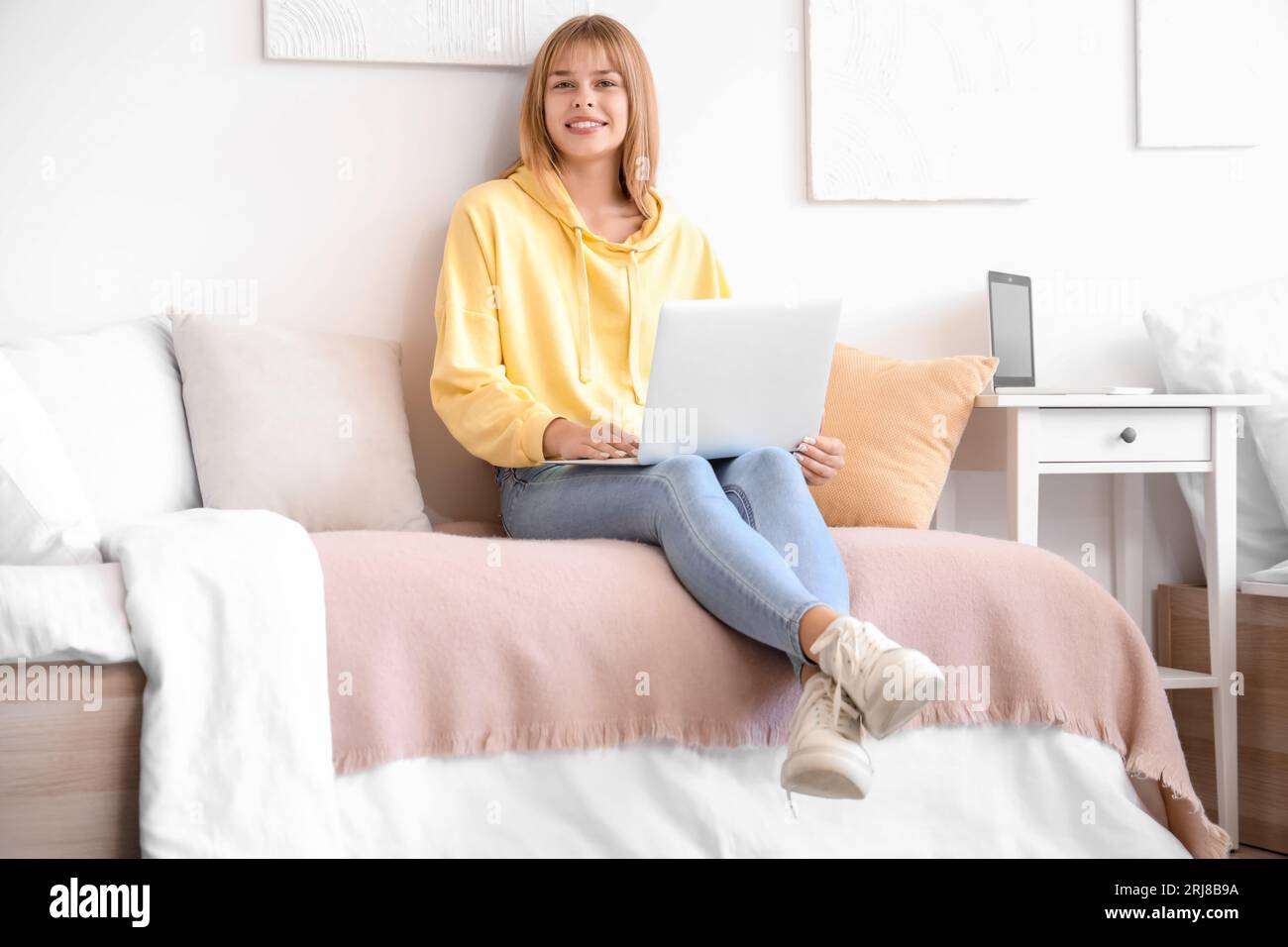Female student studying with laptop in dorm room Stock Photo - Alamy