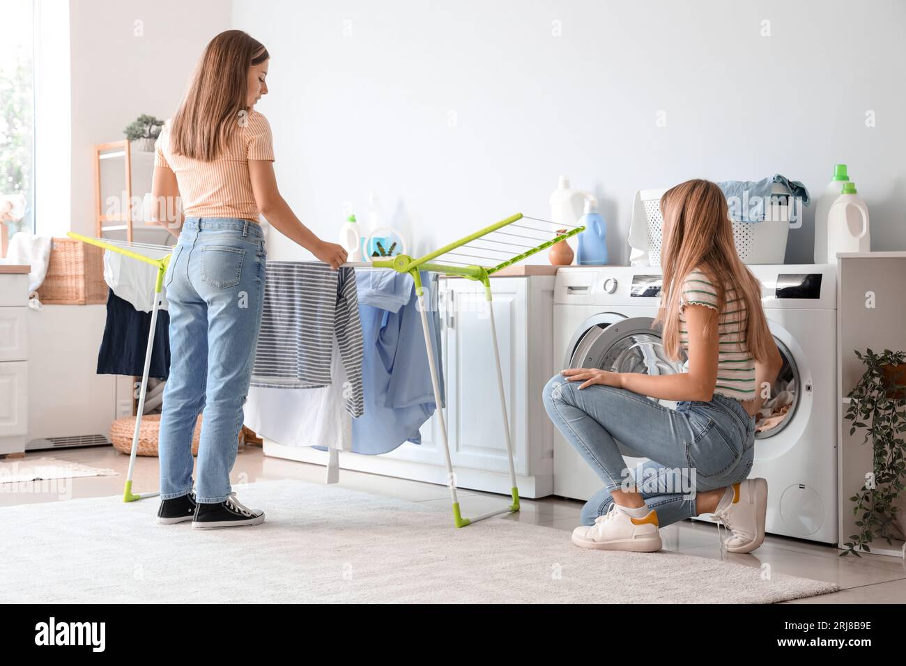 Female students doing laundry in dormitory Stock Photo - Alamy
