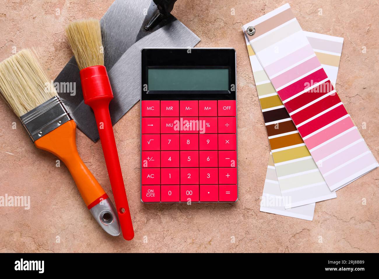 Calculator, painting tools and color samples on beige grunge background ...