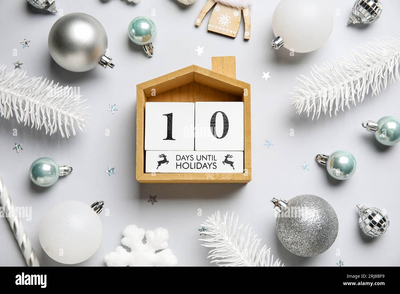 Calendar with text 10 DAYS UNTIL HOLIDAYS and Christmas decor on white ...