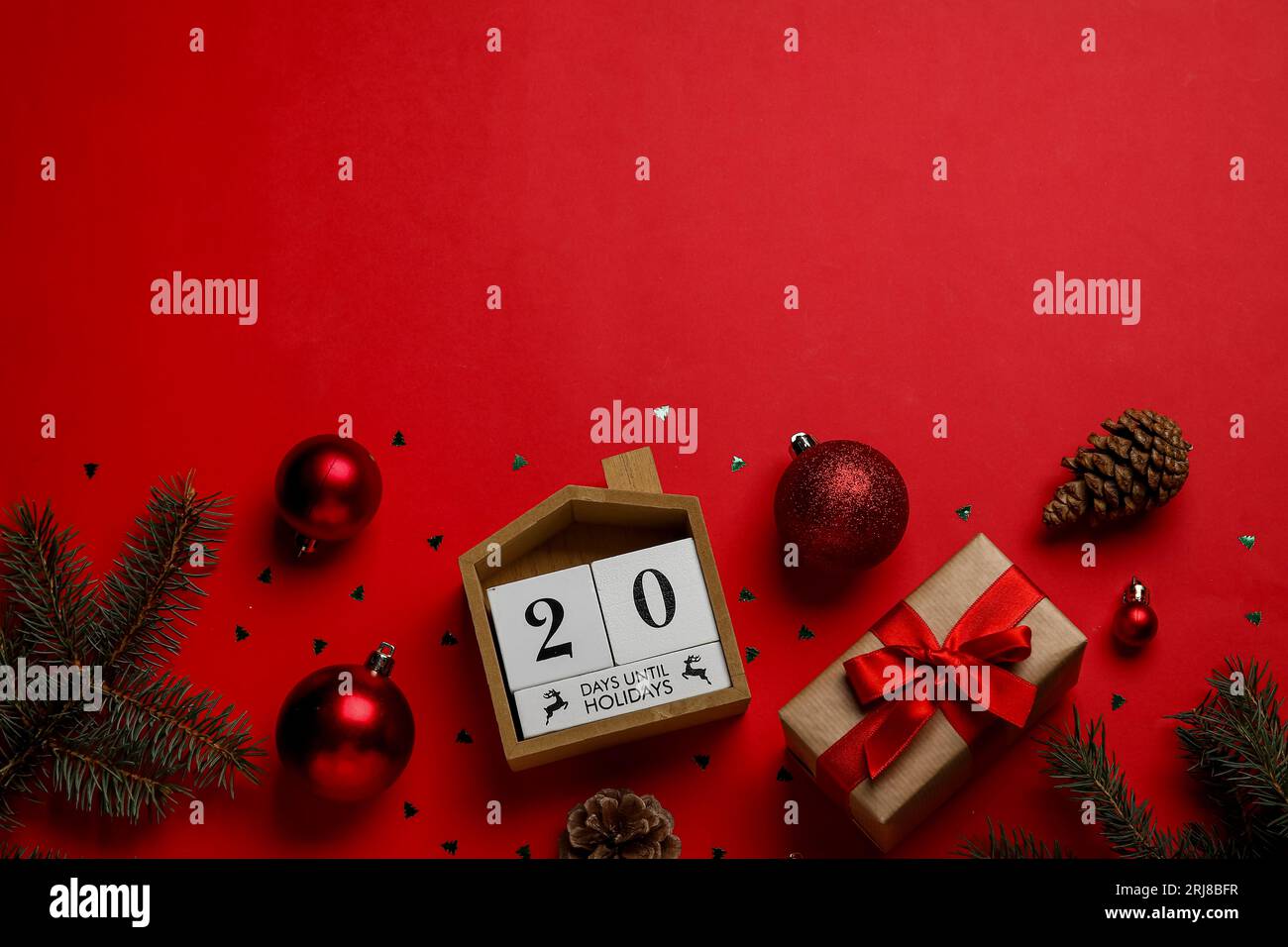 Calendar with text 20 DAYS UNTIL HOLIDAYS and Christmas decor on red ...