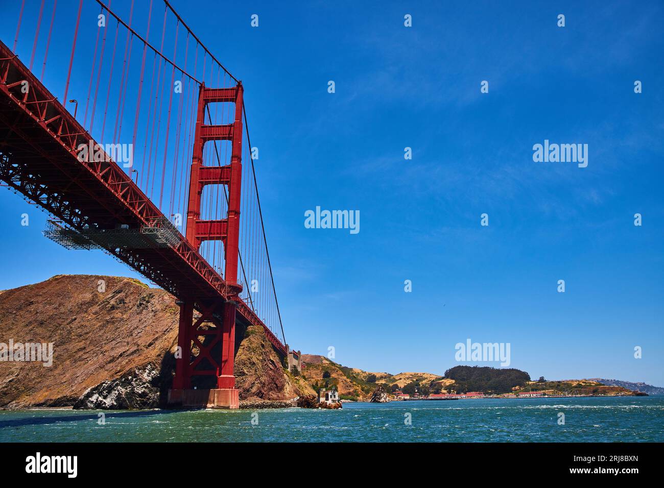 Underside and side view of Golden Gate Bridge on bright summer day with ...
