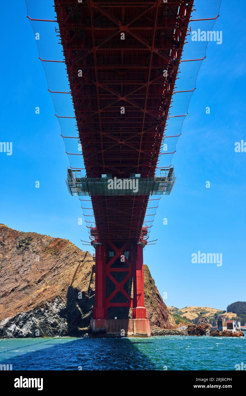 Underside view of Golden Gate Bridge with clear blue skies on bright ...