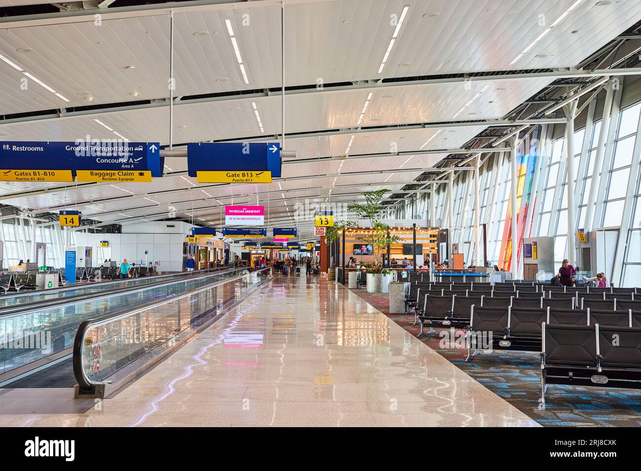 Generic airport view of hallway with moving walkway and mostly empty ...