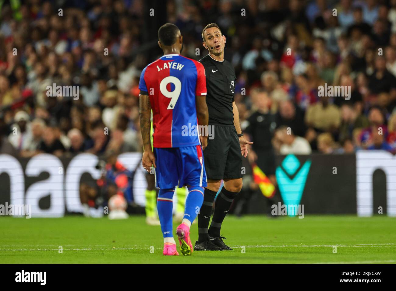 Referee David Coote speaks to Jordan Ayew #9 of Crystal Palace during ...