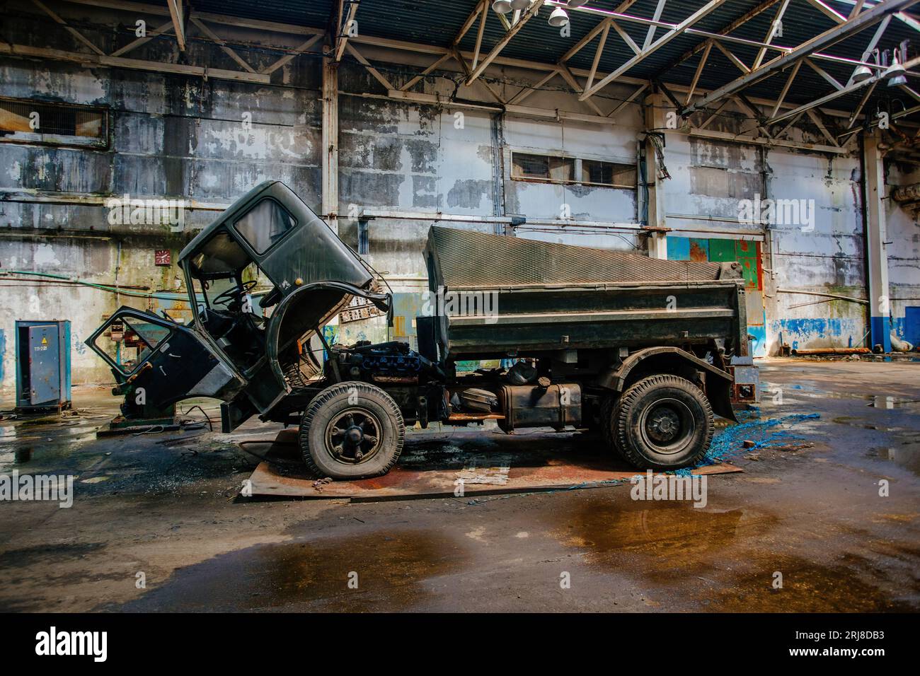 Dump truck in garage for repair Stock Photo - Alamy