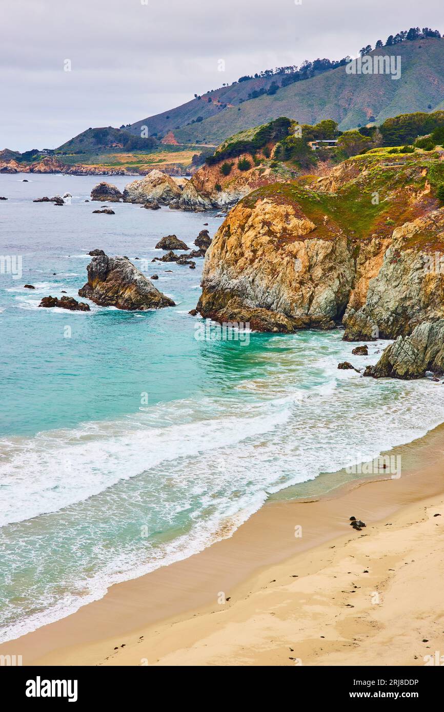 Scenic beach with ocean waves peacefully breaking against shore with ...