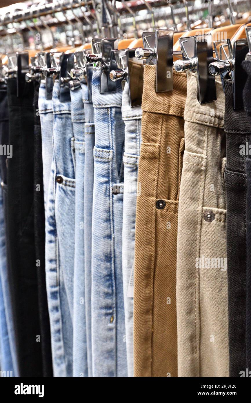 Jeans hanging on hanger in a store Stock Photo - Alamy