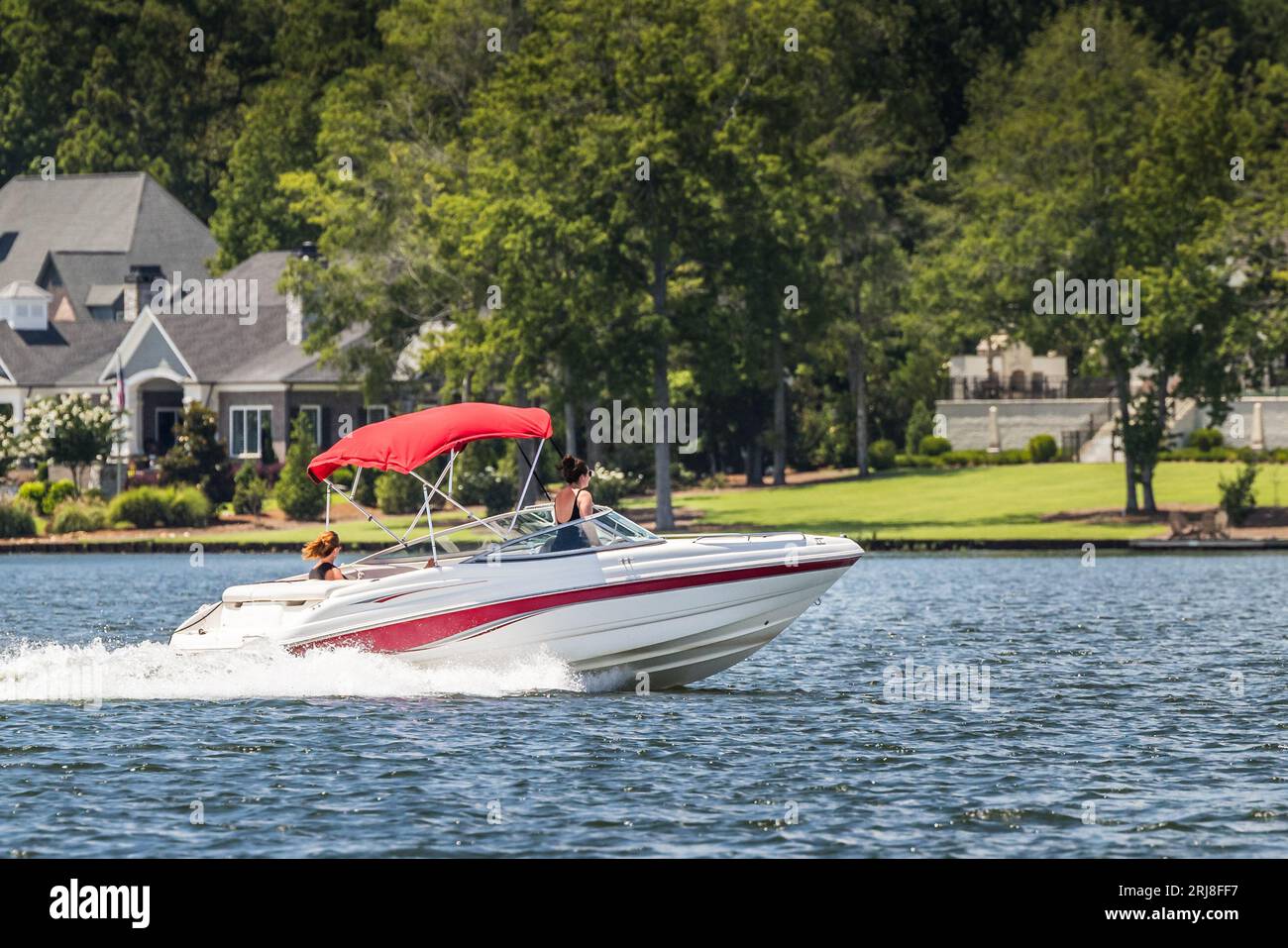 Female boaters on power boat enjoying summer day on Lake. Women in ...