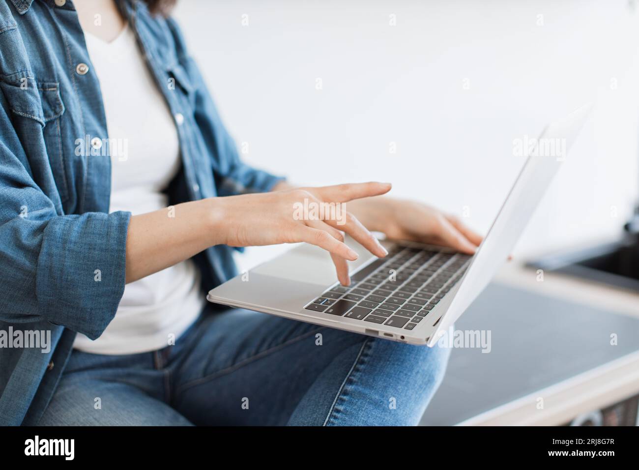 Female adult using keyboard of wireless device indoors Stock Photo - Alamy