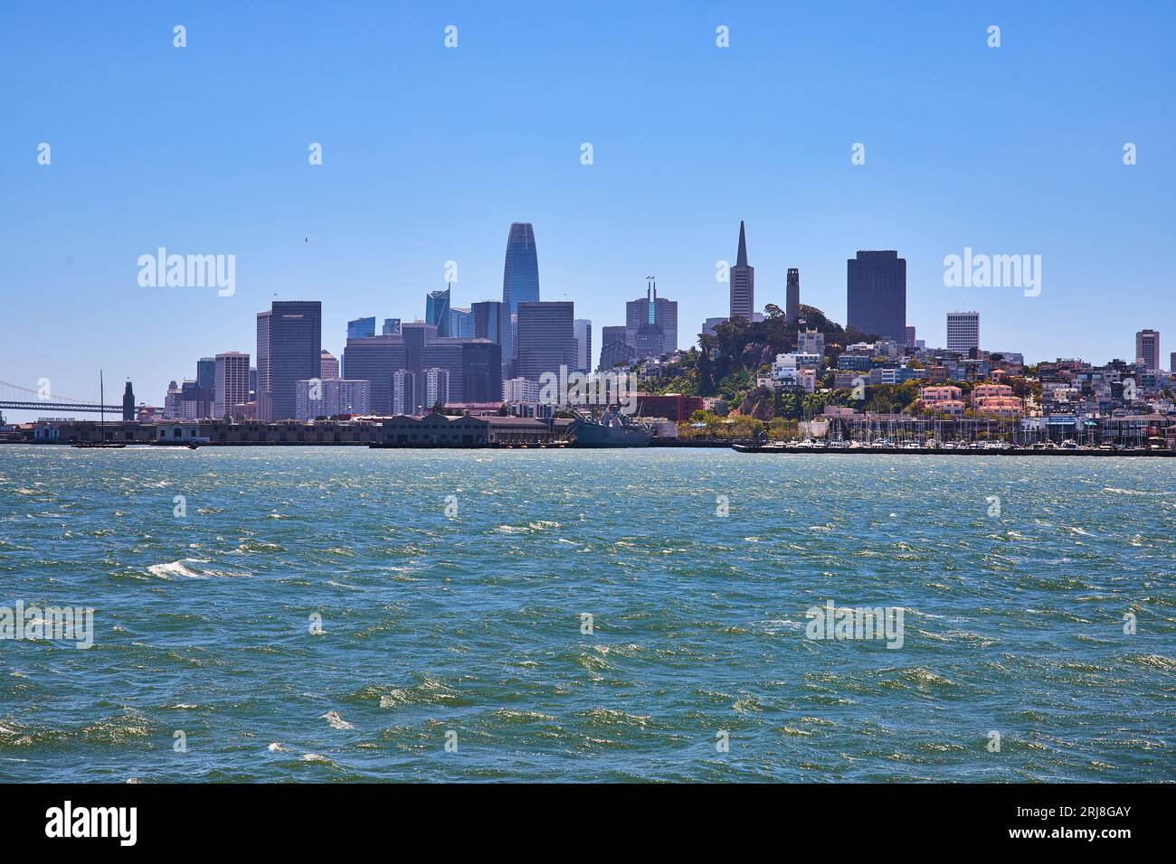 Choppy San Francisco Bay water with distant downtown skyscrapers and ...