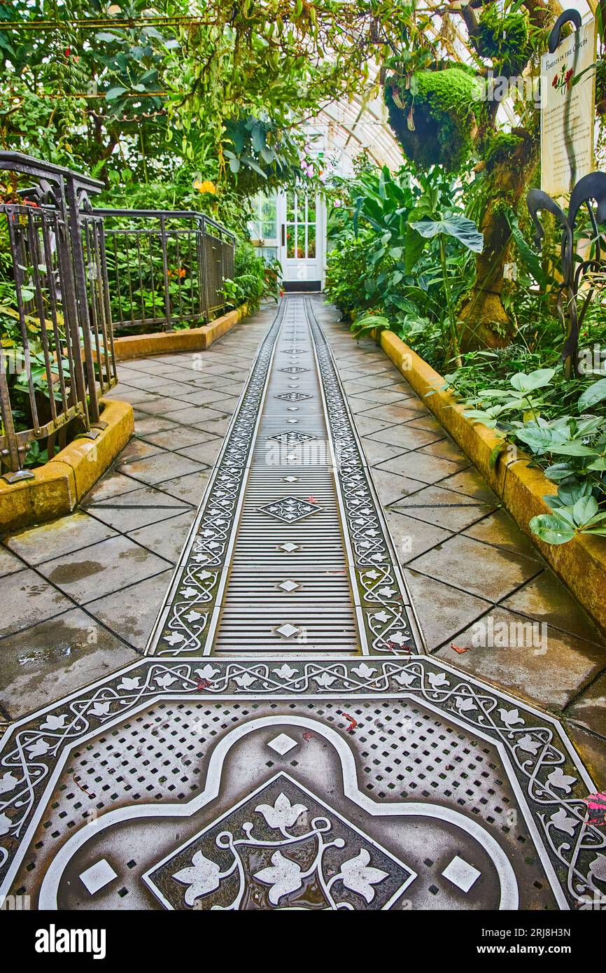 Close up of metal grating on tile walkway inside conservatory with ...