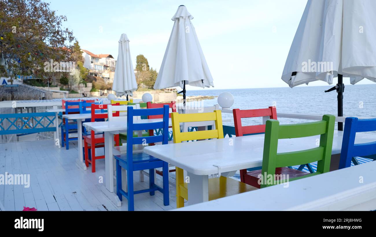Romantic sea restaurant with colorful chairs Stock Photo - Alamy