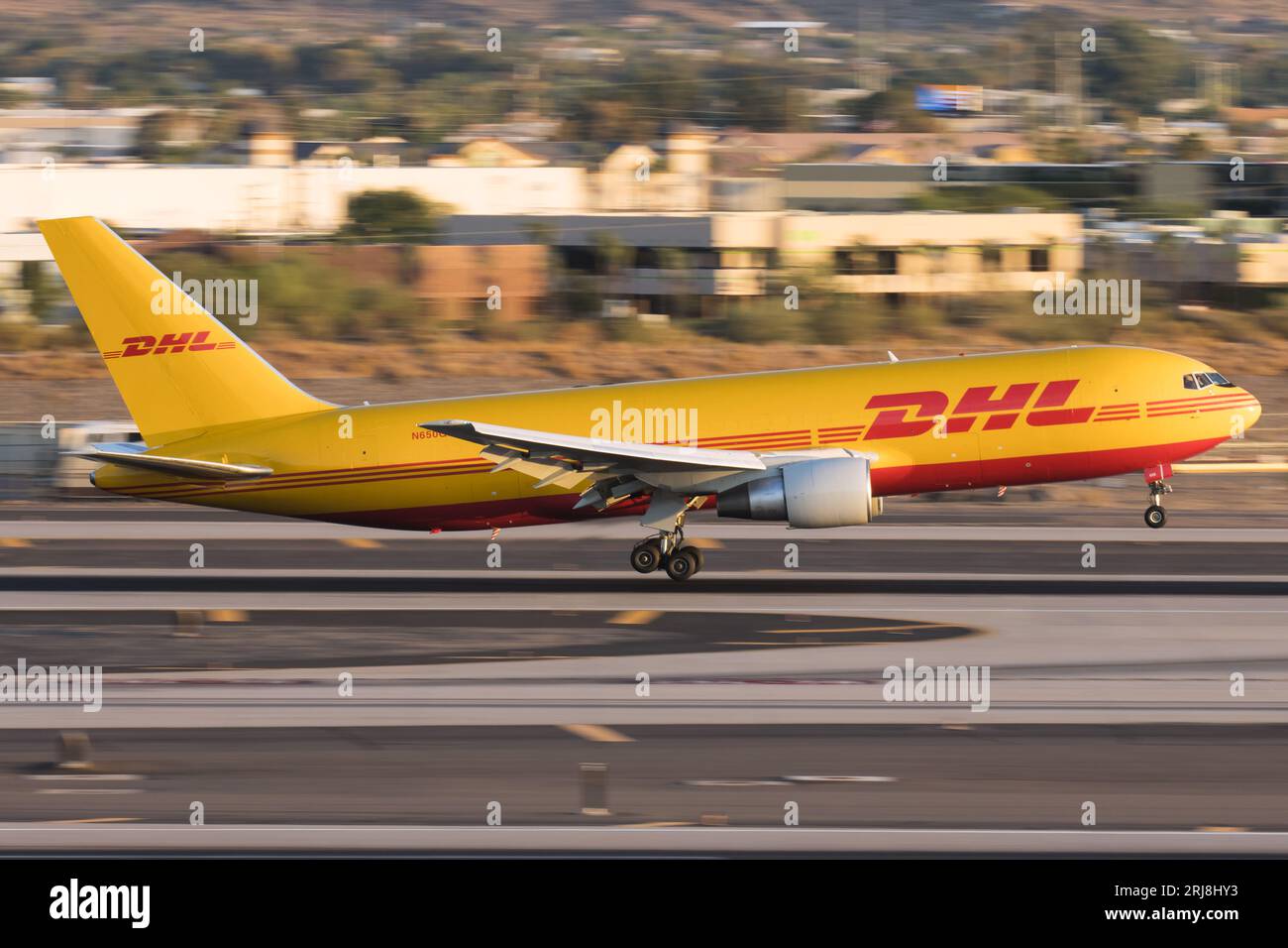 A DHL Boeing 767-200 freighter is about to touch down on runway 25L at ...