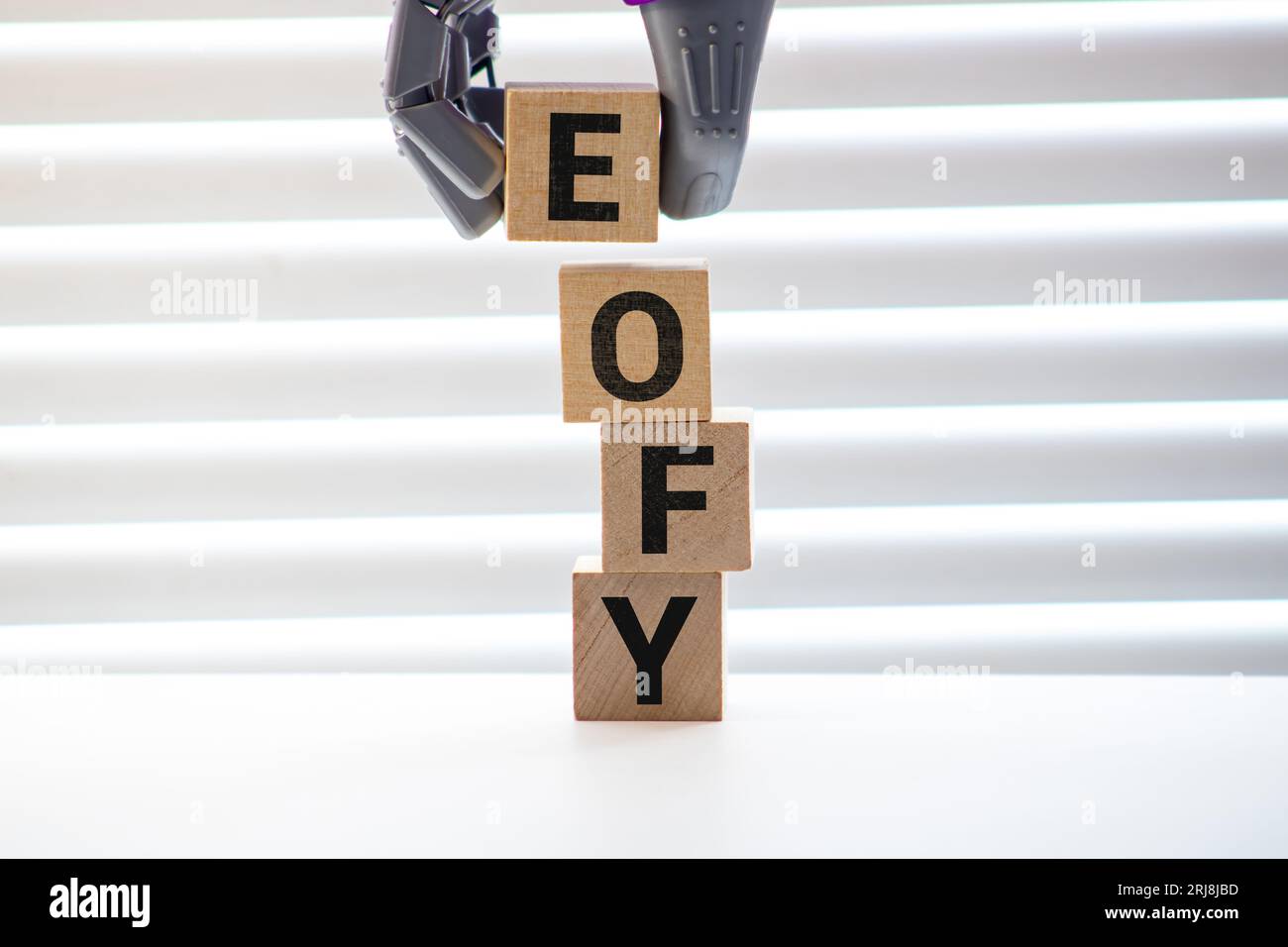 EOFY, End of Financial Year text. wood cubes and white background Stock ...