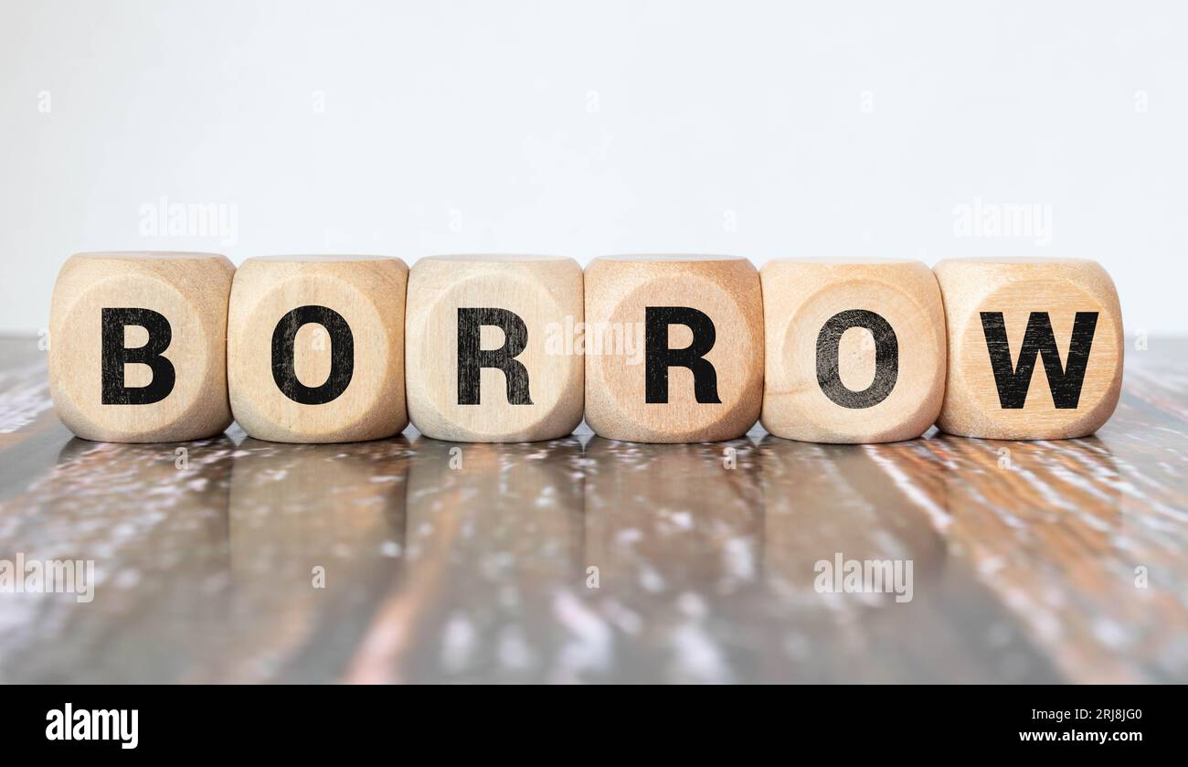 Letter block with word borrow on wood background with another alphabet ...