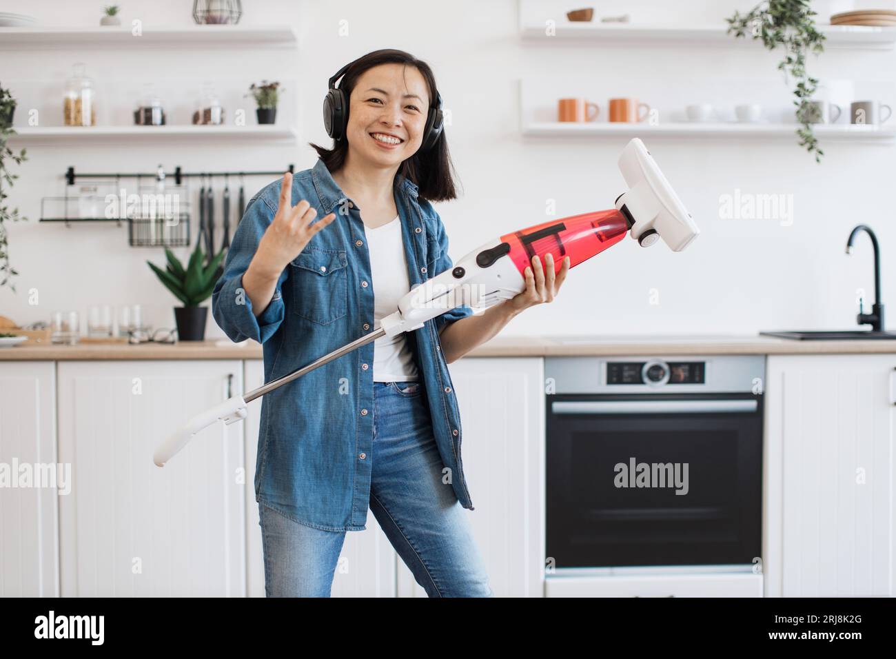 Excited asian female showing rock-on hand sign while standing with ...