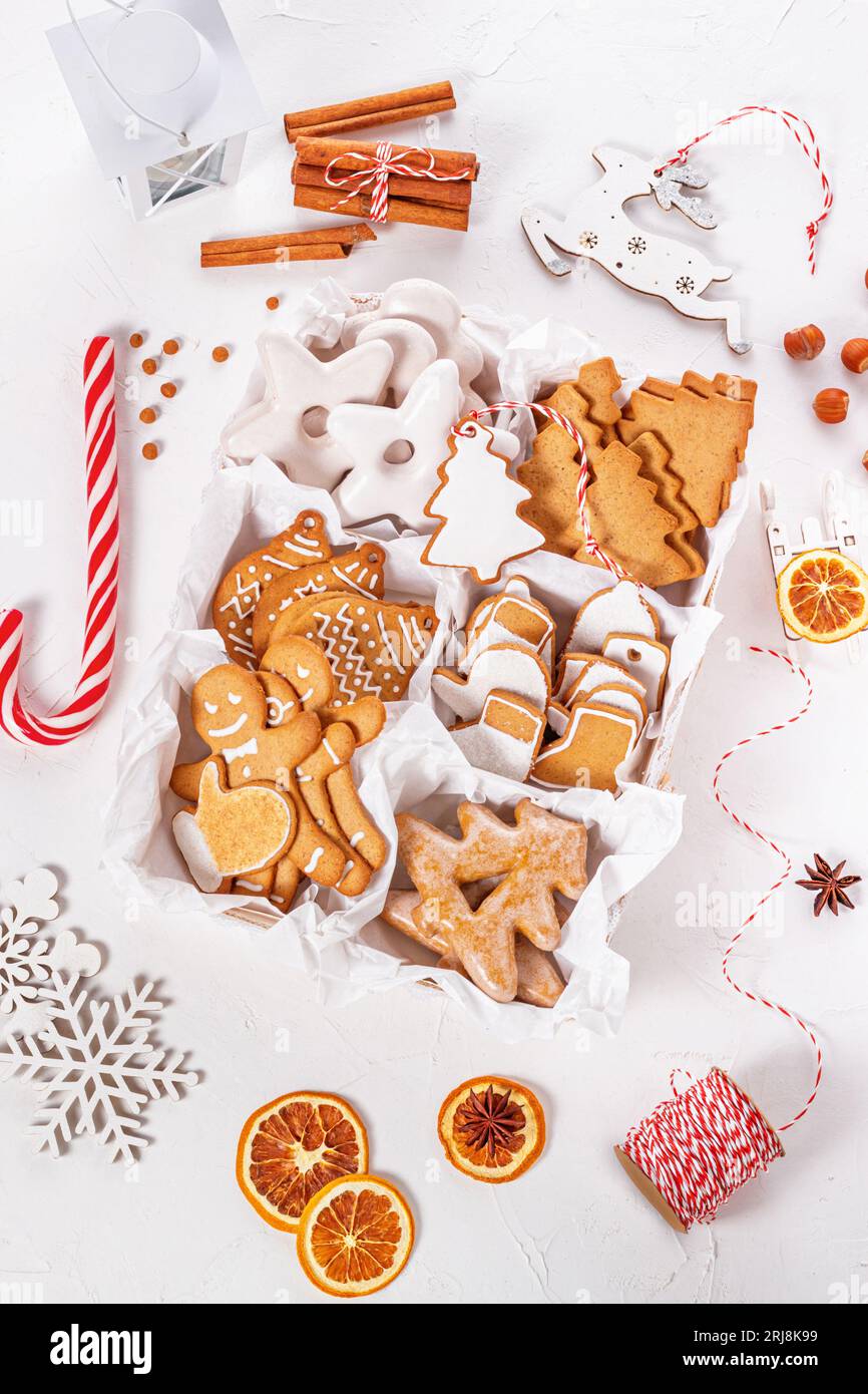 Top view of unpacked christmas present with sweets on a white textured ...