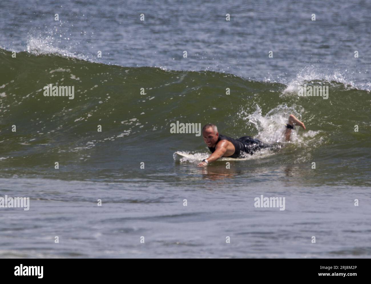 Gilgo Beach, New York, USA - 22 July 2023: A man is kicking and stoking ...