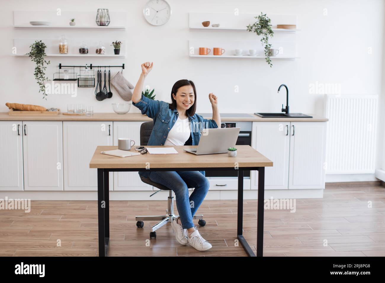 Cheerful asian woman expressing positive emotion while reading good ...