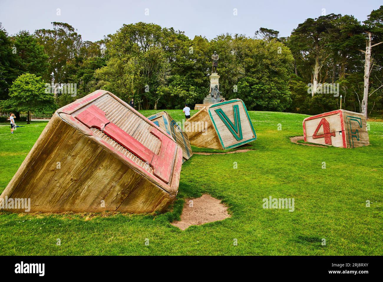 Grassy field with giant wooden stackable blocks with letters and ...