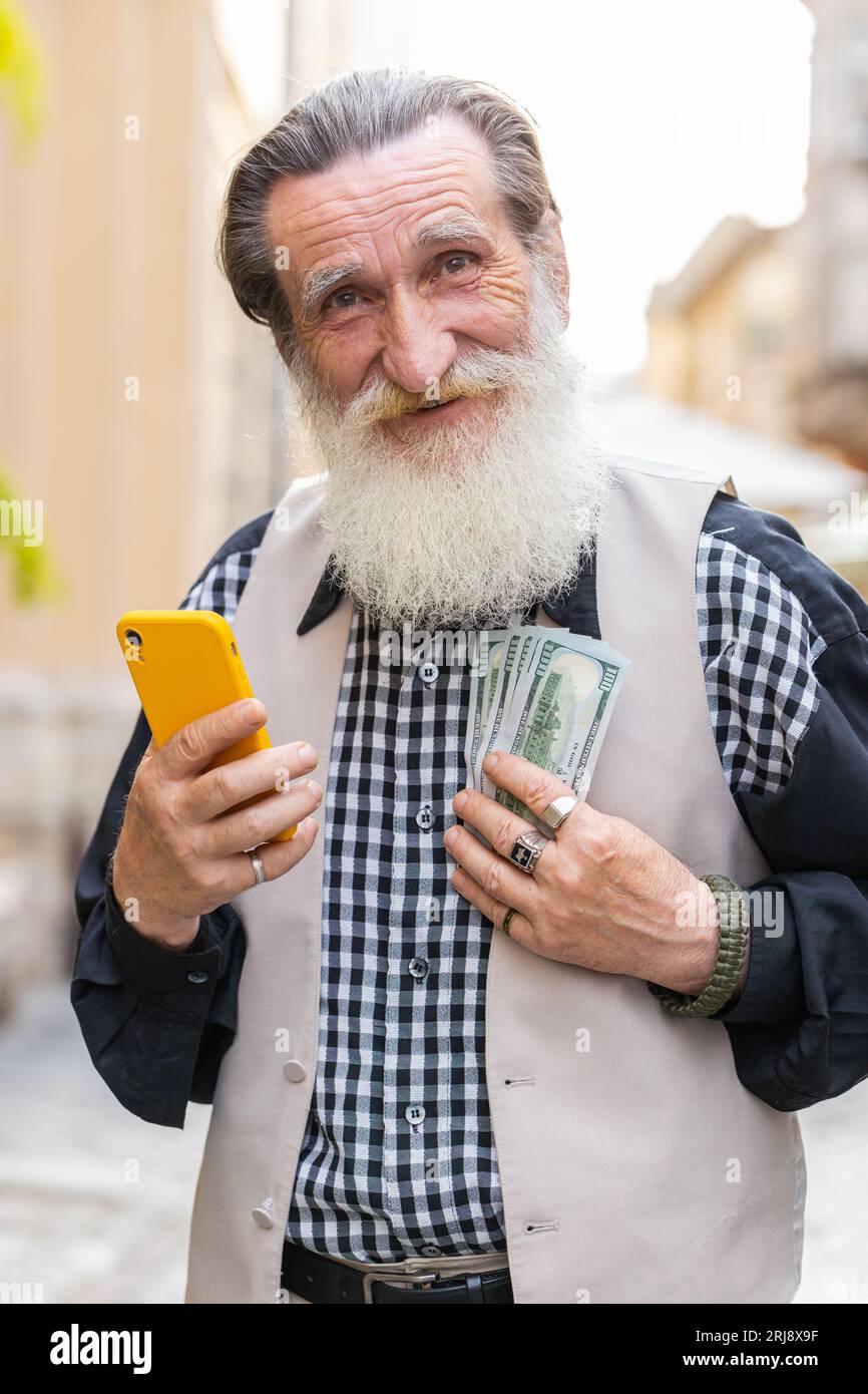 Happy rich senior old man counting holding money dollar cash, use ...