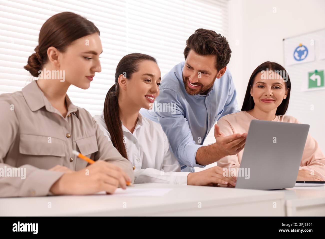 Happy teacher giving lesson hi-res stock photography and images - Alamy
