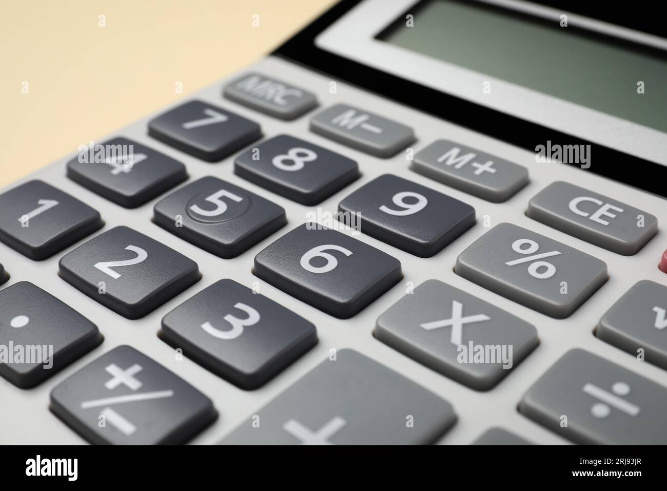 Calculator on beige background, closeup. Office equipment Stock Photo ...