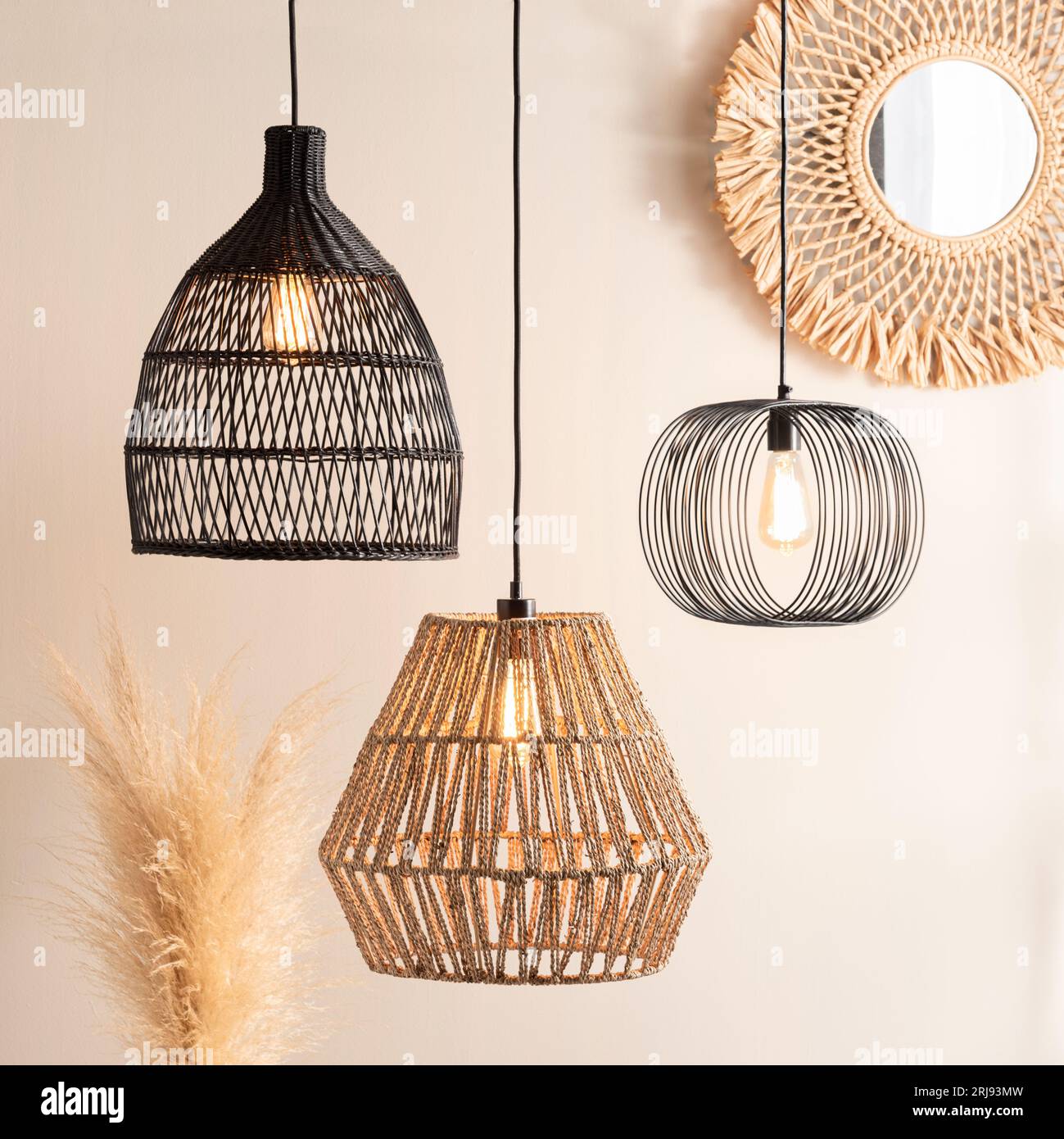 Three rattan-style ceiling lights hanging on an off-white wall, with ...